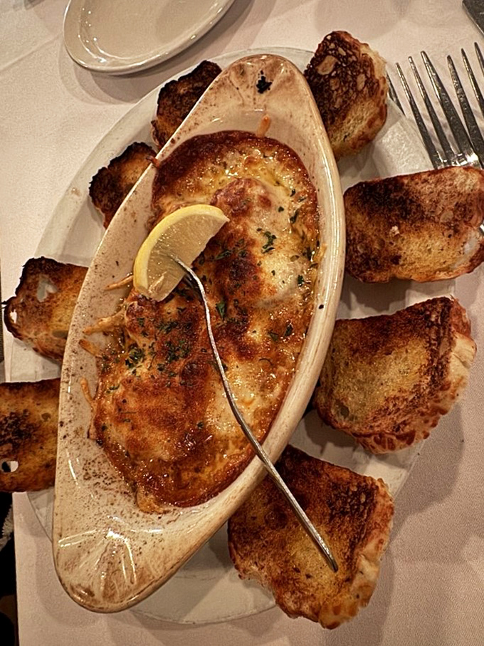 This seafood dish surrounded by toasted crostini isn't just food; it's edible architecture that tastes as good as it looks.