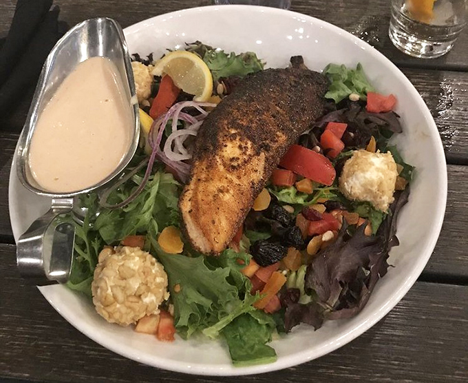 A salad that doesn't feel like punishment &ndash; perfectly blackened salmon atop a garden of greens with those adorable cheese bites.