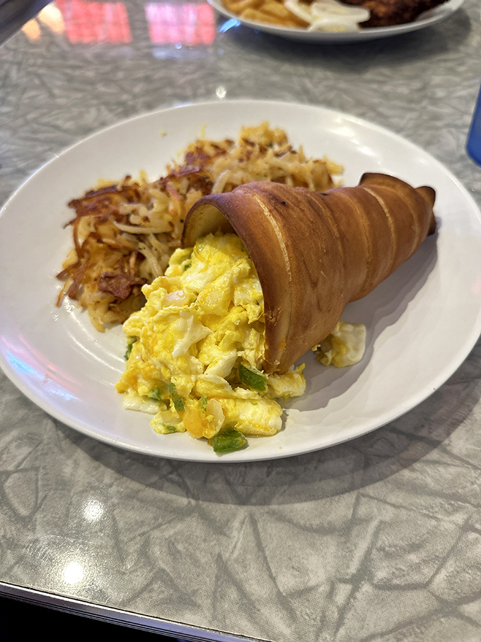 Breakfast innovation that would make Einstein proud &ndash; scrambled eggs nestled in a pastry horn with crispy hash browns standing guard.
