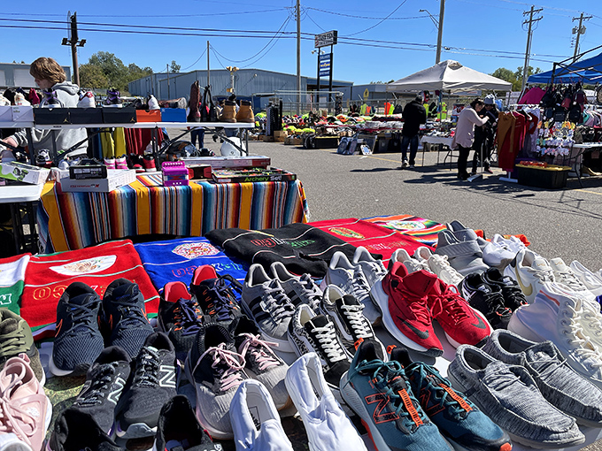 The outdoor market's sneaker selection sprawls across tables like an athletic rainbow. Each pair tells a story—some barely worn, others well-loved.