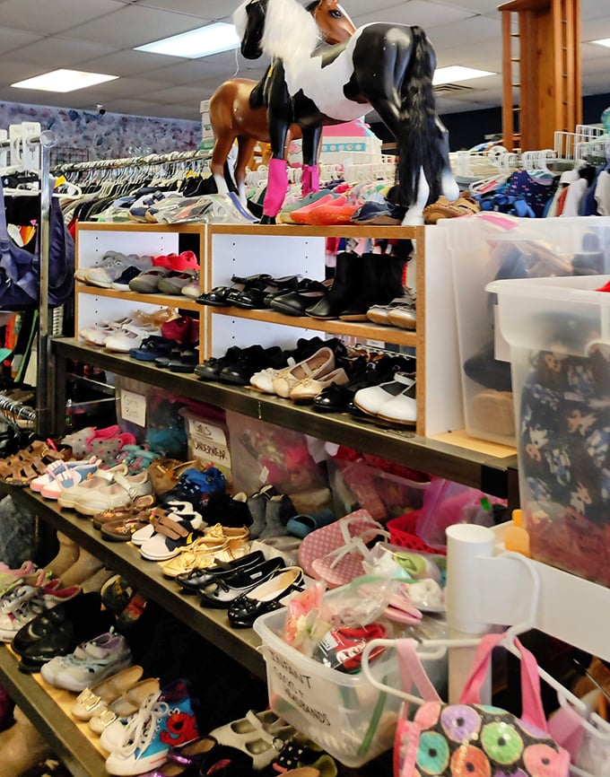 Footwear fantasyland! Those plastic horses stand guard over an impressive collection of barely-worn shoes seeking their Cinderella moment.