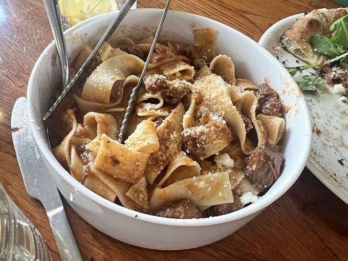 Pasta that doesn't mess around—wide ribbons embracing tender short rib in a sauce that clearly simmered while someone's Italian grandmother supervised.