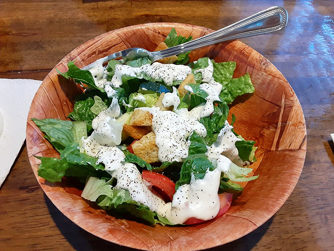 Even the salad gets the wooden bowl treatment &ndash; crisp greens, fresh veggies, and dressing that wasn't poured from a bottle that's been sitting around since 2019.
