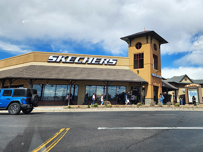 Skechers knows how to make an entrance with that distinctive tower. The blue Jeep parked outside is clearly ready for an adventure after its owner finds comfortable footwear.