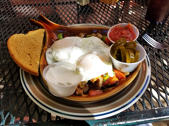 A skillet breakfast that's essentially the United Nations of morning foods—eggs, potatoes, and pickled jalapeños creating delicious diplomatic relations.