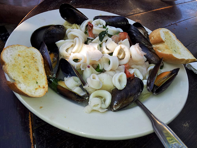 The seafood pasta arrives like an oceanic treasure chest&mdash;mussels, calamari, and pasta swimming in a broth worth drinking directly from the bowl.