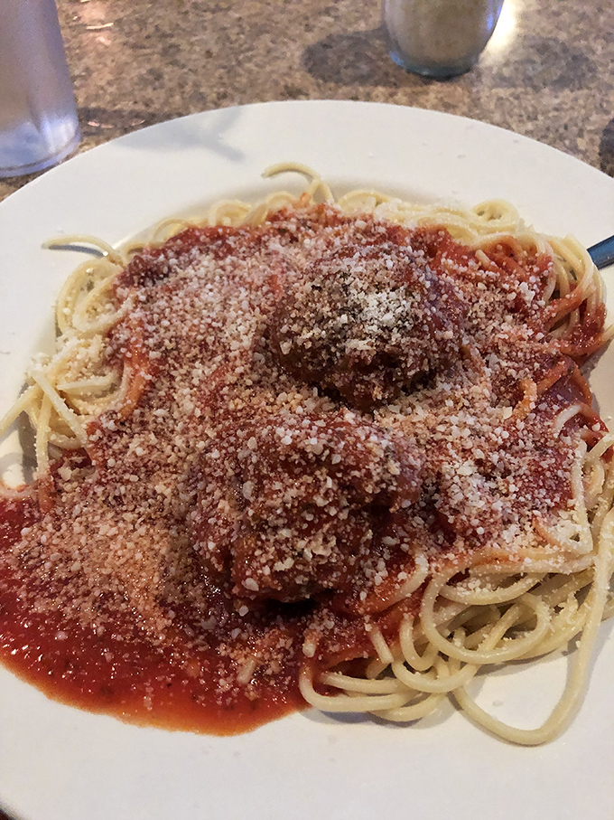 Spaghetti and meatballs done right – no fancy twirls needed, just pure pasta perfection on a plate.