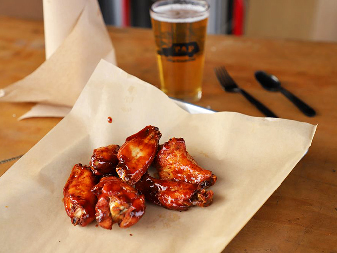 Wings glazed to sticky perfection, paired with a cold beer because this is how happiness looks on a plate.