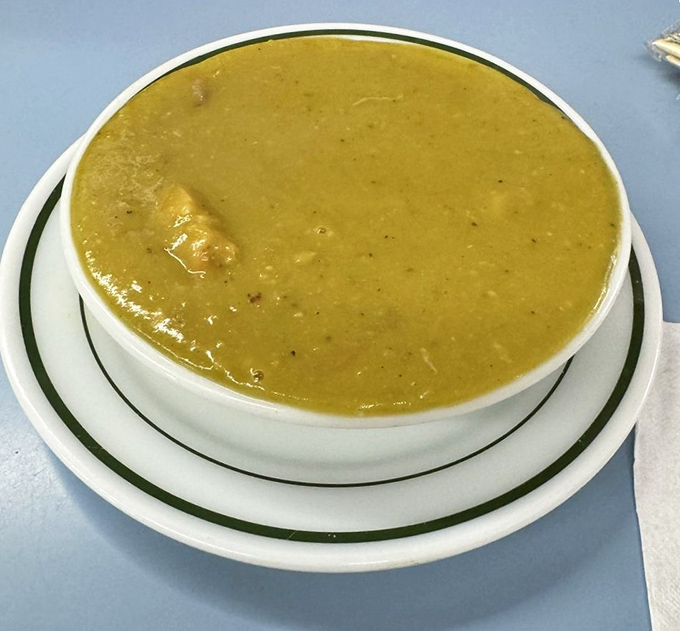 Split pea soup so thick a spoon could stand at attention. This bowl of green gold contains chunks of ham that elevate it from mere soup to culinary treasure.