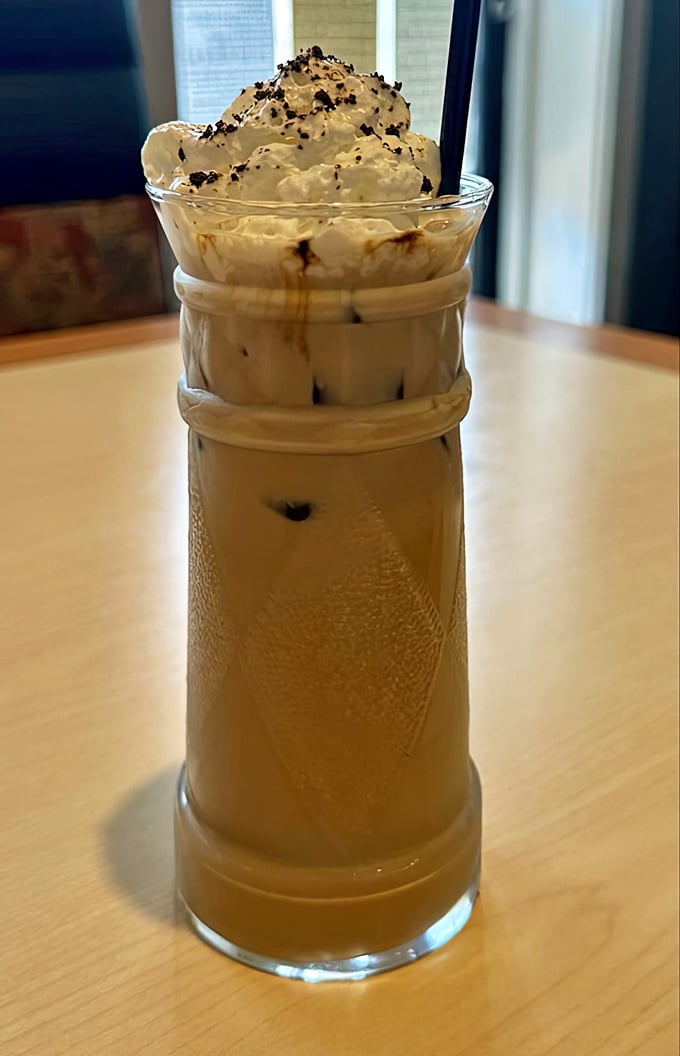 This isn't just iced coffee; it's a tower of caffeinated bliss topped with whipped cream that makes your regular morning brew look like it's not even trying.