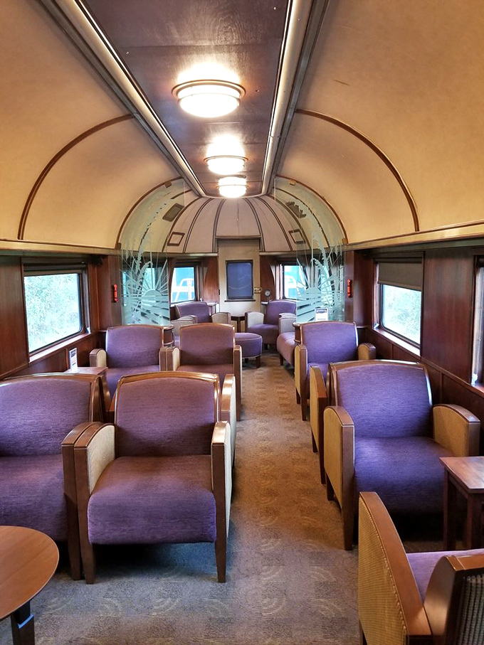 Plush purple seating that would make Prince nod in approval. Mid-century modern meets railroad elegance in this rolling living room.