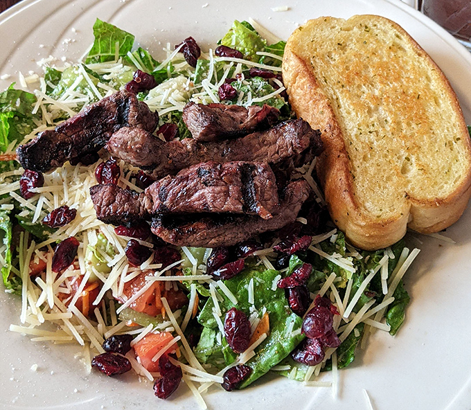 Who said salads can't be exciting? This one's having an identity crisis – part health food, part indulgence with those perfectly grilled steak strips and cranberries adding pops of flavor.