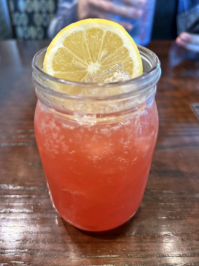 That strawberry lemonade isn't just a drink&mdash;it's summer in a mason jar, with a slice of lemon standing guard against ordinary refreshment.