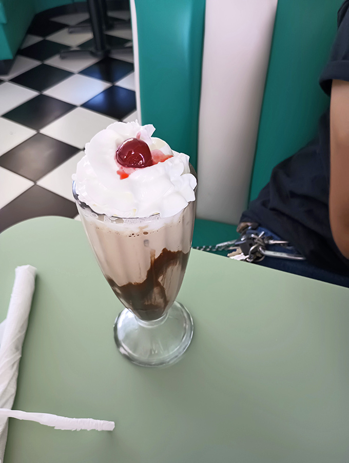 This isn't just a milkshake &ndash; it's a towering monument to dairy devotion, crowned with whipped cream and a cherry that demands to be photographed.
