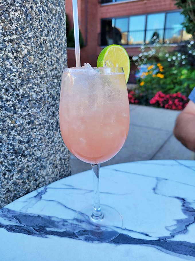 The Strawberry Fields Spritz—where refreshment meets elegance. Like summer in a glass, with that lime wedge standing guard over all that delicious pink promise.