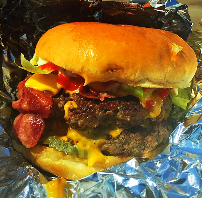 When a burger requires both hands and a strategy session before the first bite, you know you're in for something special.