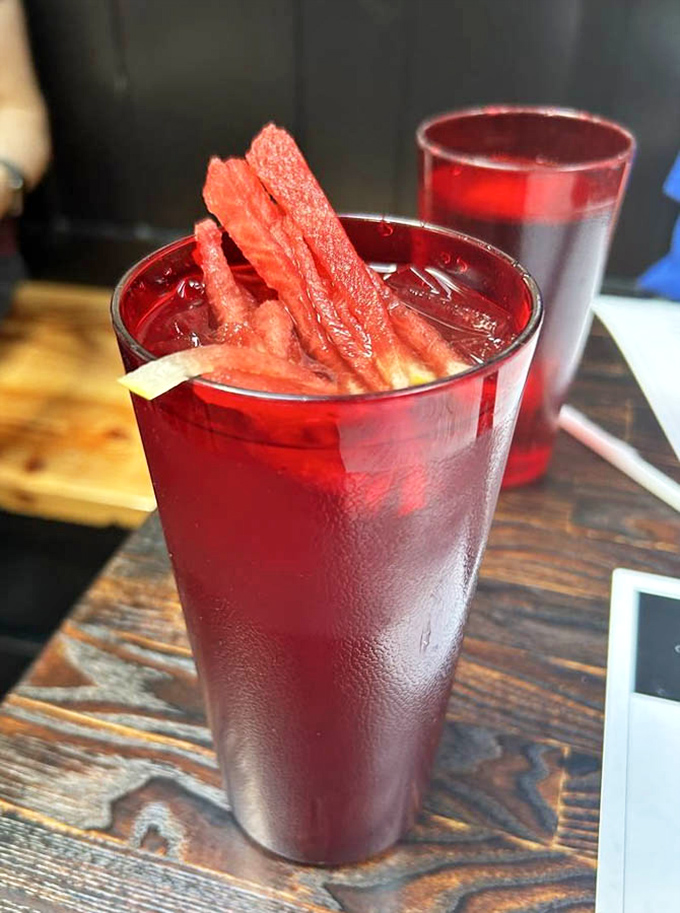 That's not just any red drink&mdash;it's watermelon tea with actual watermelon spears, like summer decided to throw itself a party in a glass.