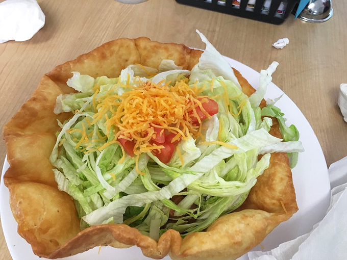 A taco salad that's actually a crispy edible bowl holding fresh ingredients. It's like someone said, "Let's make the plate delicious too!"