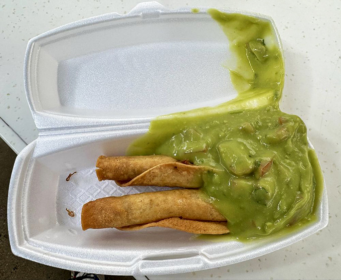 Golden taquitos lounging beside a pool of vibrant green guacamole—crispy, crunchy tubes of joy waiting to transport you to flavor country.