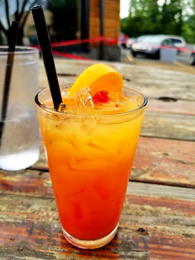 A sunset in a glass &ndash; this tequila sunrise sits on a weathered wooden table, promising good times ahead.