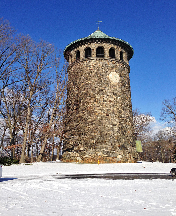 Winter transforms Rockford Tower into something straight out of a holiday card—its weathered stones and green copper roof dusted with Delaware's seasonal snowfall.