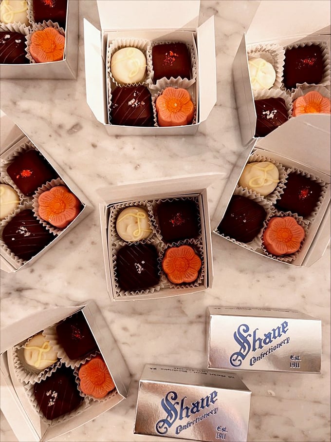 Tiny boxes of artisanal truffles arranged like a marble chess board&mdash;a game where every move ends in victory and chocolate-stained fingers are badges of honor. 