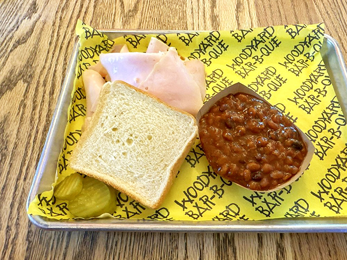 A simple turkey sandwich elevated to art form through the magic of smoke. Those baked beans alongside aren't just a side&mdash;they're a revelation.