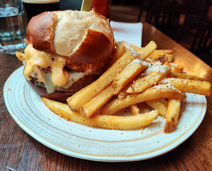 Melted cheese cascading down like a dairy waterfall over a perfectly cooked patty. This isn't just a burger&mdash;it's performance art you can eat.