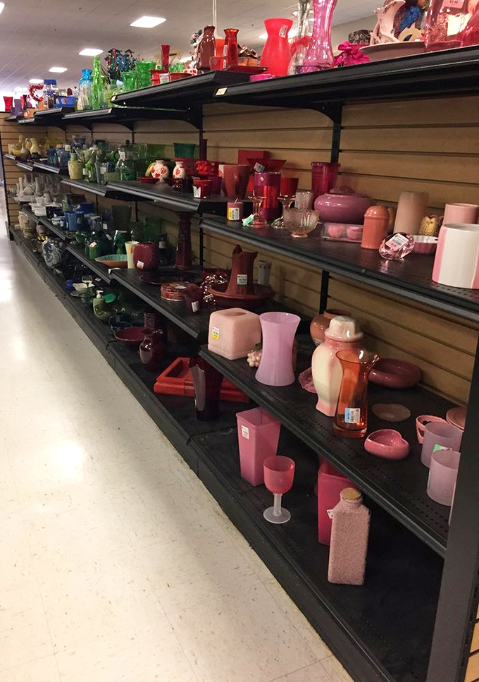 A rainbow of vintage glassware arranged by color creates an almost museum-like display. Each piece silently whispering stories of dinner parties past.