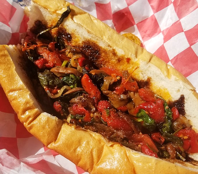 A symphony of colors and textures &ndash; this sandwich bursts with roasted peppers and savory fillings nestled in a perfectly crusty roll.