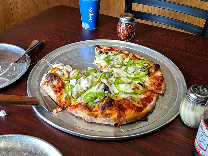 Green peppers arranged like modern art on a canvas of perfectly melted cheese. This veggie pizza proves eating your vegetables can be a joyous occasion.