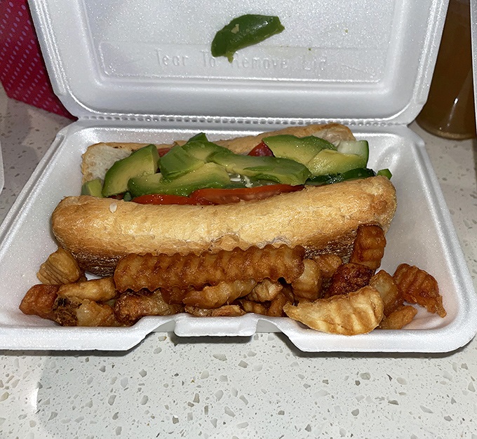 This sandwich with avocado and fresh veggies proves that even in a beef temple, plant-lovers can find their happy place.