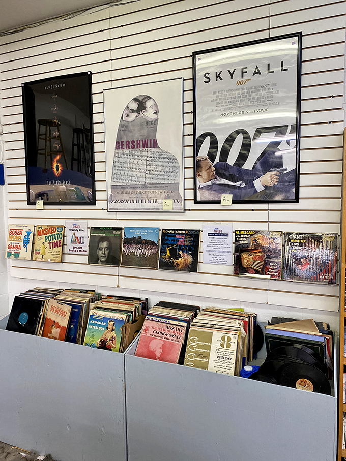 Vinyl records and movie posters create a time capsule of entertainment. James Bond watches over a collection that would make any collector swoon.