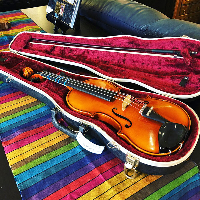 A violin waiting for its next concerto. Musical instruments here are like rescue pets&mdash;they just need someone to take them home and love them again.