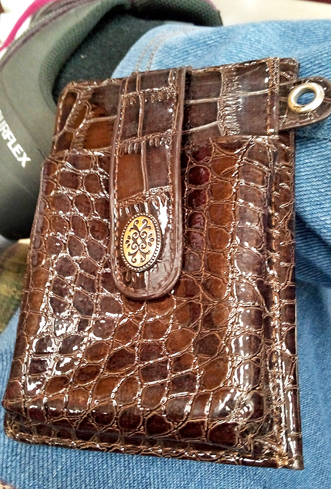 This crocodile-textured wallet once held someone else's secrets and credit cards &ndash; now it awaits your Costco membership and coffee punch cards.