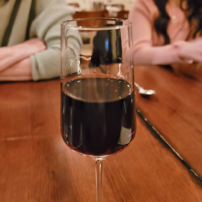 That glass of red wine catching the light is your reminder that good wine doesn't require a sommelier's vocabulary to enjoy properly.