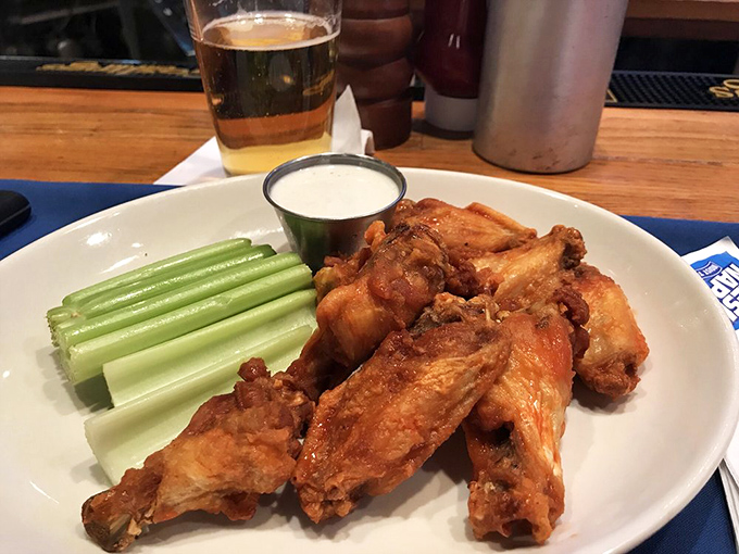 Wings that strike that perfect balance between crispy exterior and juicy interior, with celery sticks standing by for their supporting role.