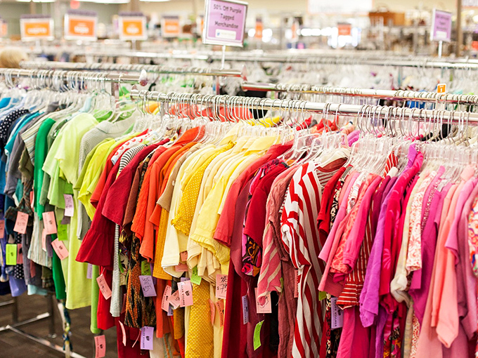 A rainbow of possibilities arranged by hue rather than size. This technicolor display of tops makes shopping feel like selecting candy from a particularly fashionable jar.
