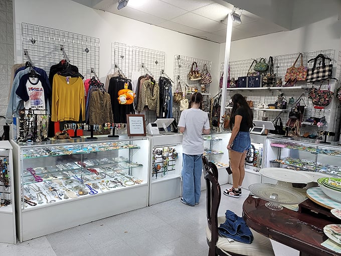 The accessories corner—where yesterday's statement pieces wait for their second act. That display case has seen more drama than a season finale of your favorite show.