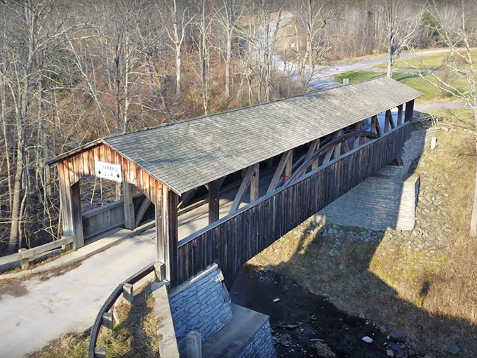 From above, Knapp's Bridge resembles a wooden sentinel keeping watch over the creek below. Its weathered roof tells tales of countless seasons.