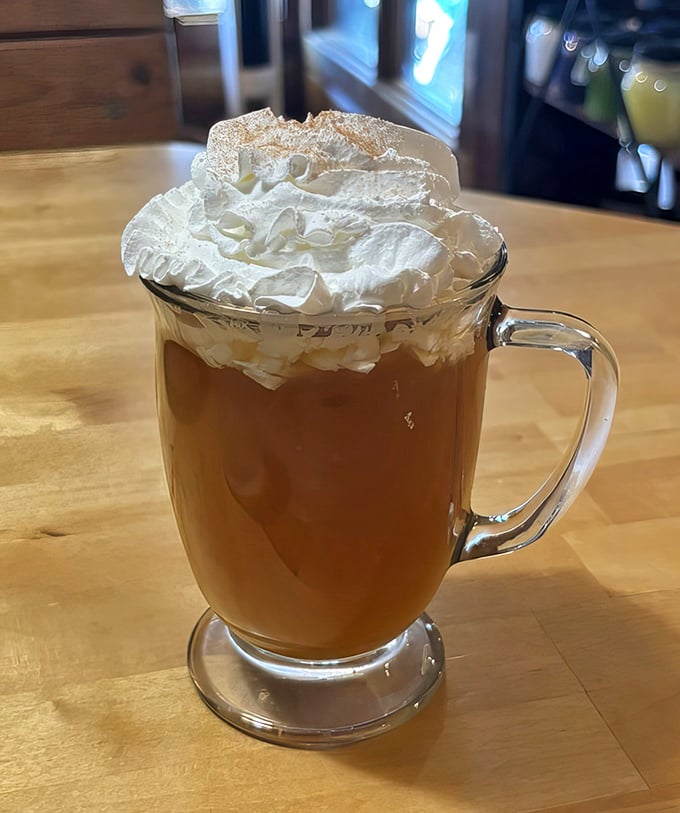 Hot apple cider crowned with a cloud of whipped cream&mdash;like autumn in a mug and the perfect companion while you debate which pie to order next.