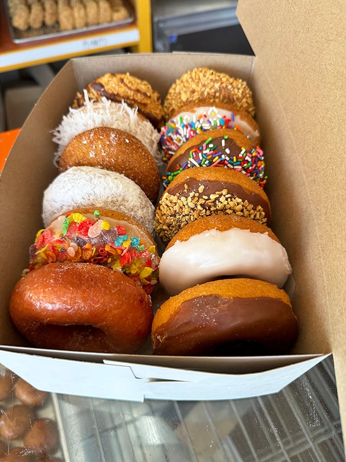 A dozen donuts arranged like edible jewelry. The hardest decision you'll make today is which one to eat first.