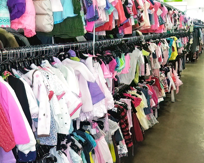 A rainbow of tiny garments awaits new adventures. These previously-loved children's clothes have stories to tell and miles left to travel.