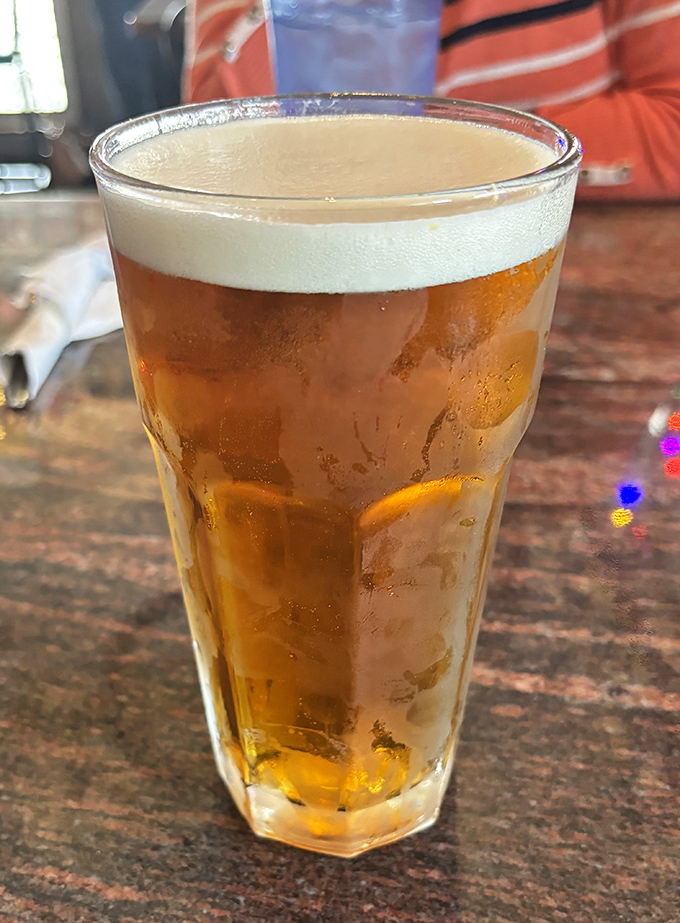 A cold beer at Gasoline Alley isn't just a drink &ndash; it's the perfect companion to wings that demand proper liquid appreciation.