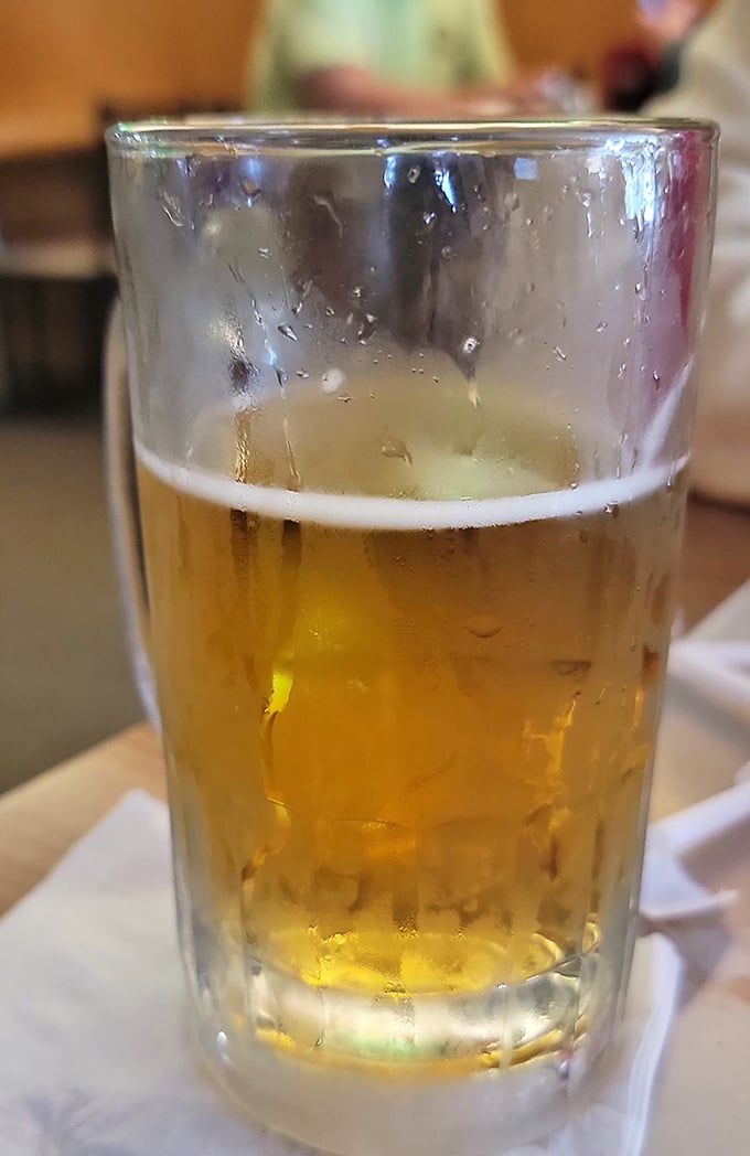 Cold beer in a no-nonsense glass &ndash; because sometimes the perfect pizza pairing doesn't need a fancy stem or artisanal backstory.