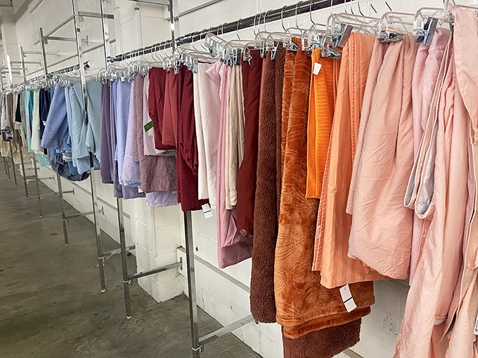 A rainbow of linens and robes hangs in chromatic order, like a textile color wheel waiting to brighten someone's bathroom or bedroom.