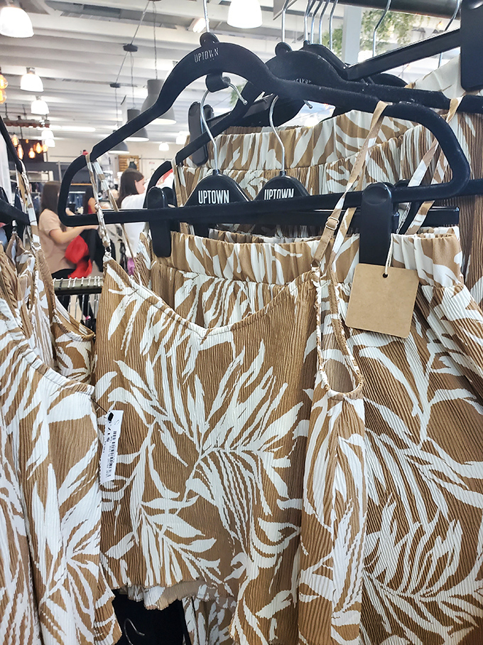 Pattern paradise! Tropical-inspired pieces hang ready for their second act, proving sustainable fashion can be as stylish as it is sensible.