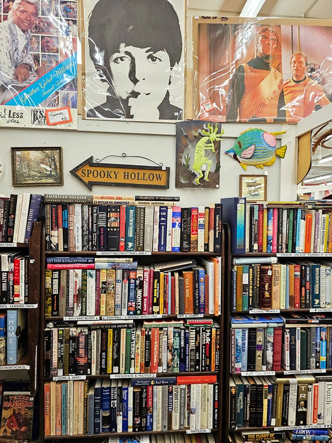 Literary treasures stacked beneath pop culture icons. That "Spooky Hollow" sign points the way to your next great bookshelf adventure.
