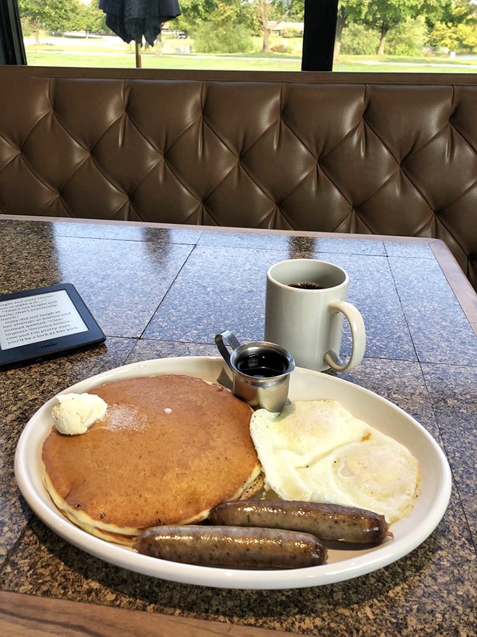 The breakfast trinity—pancake, egg, and sausage—arranged on a plate like old friends who've gathered to make your morning magnificent.