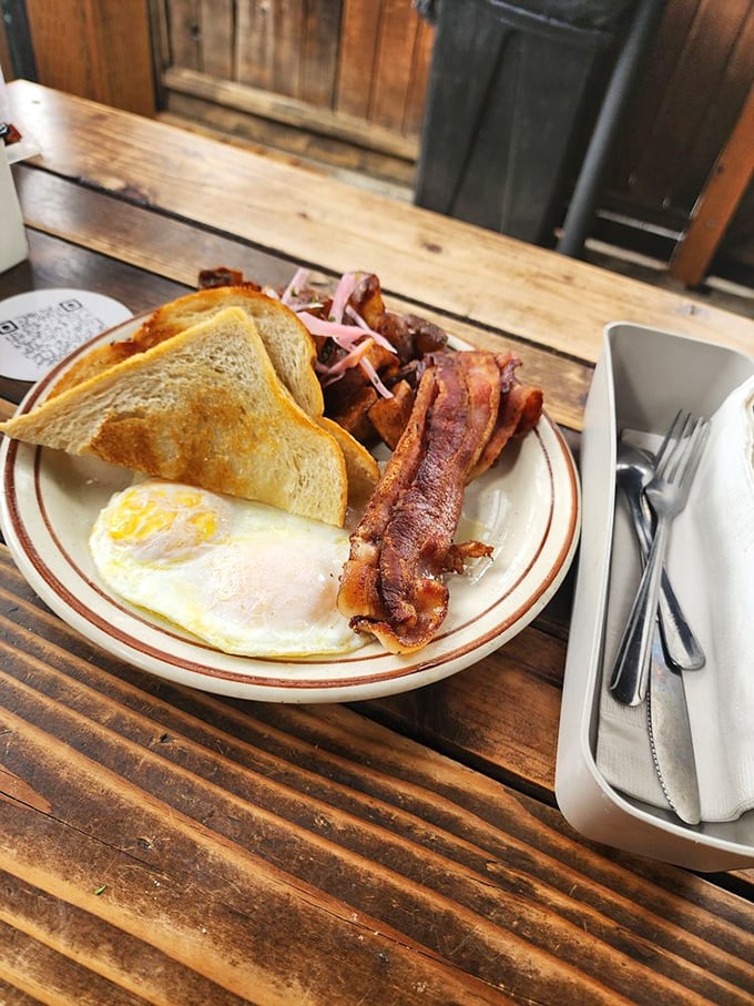 The classic breakfast done right. That bacon looks like it's auditioning for a food commercial, and it just got the part.